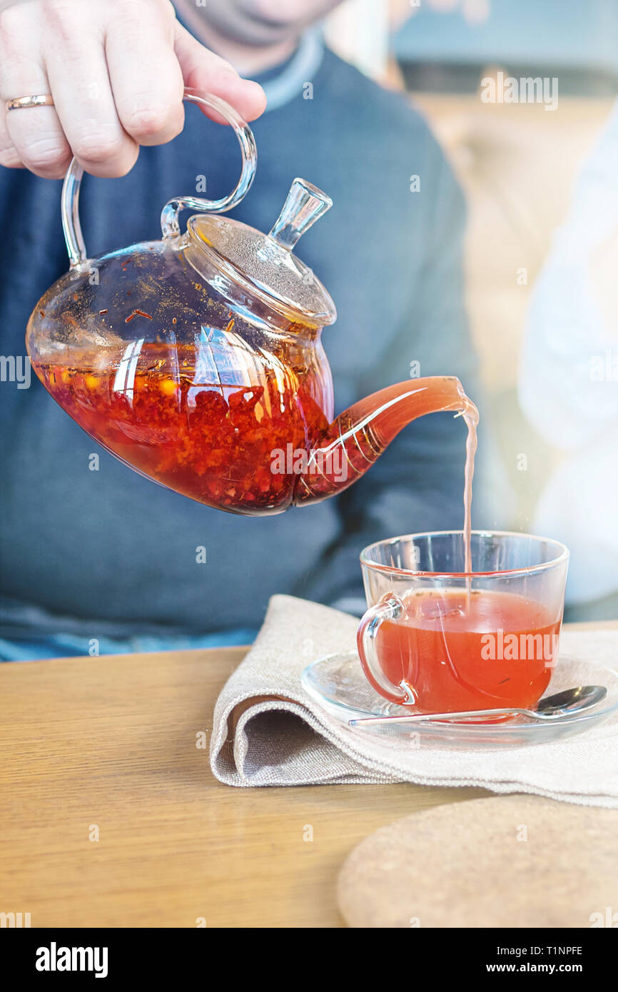 process of brewing tea, a Cup of freshly brewed fruit tea of red fruit ...
