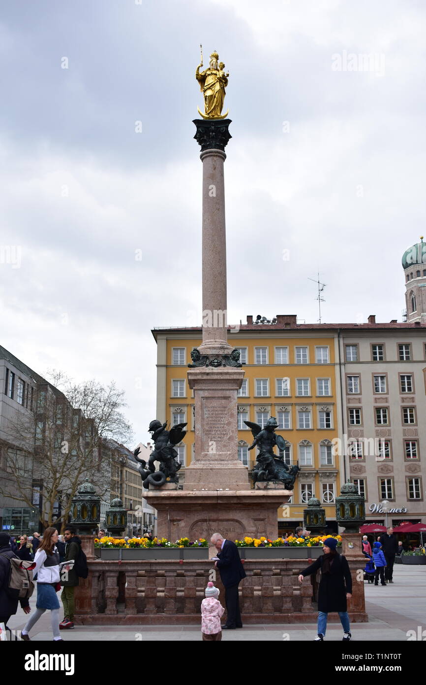Column with little statues and flowers on the Marienplatz in Munich ...