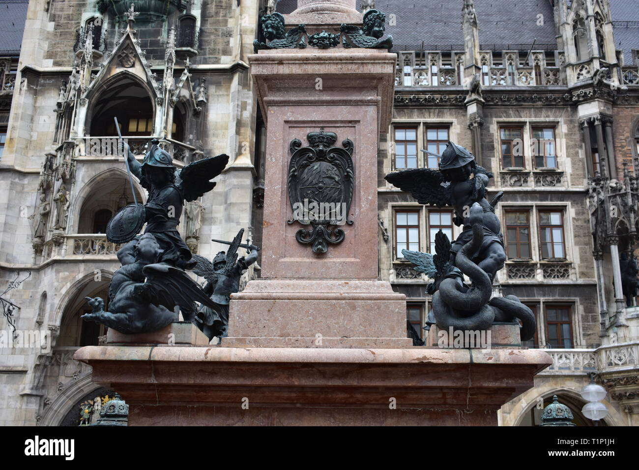 Two angle statues with shield and sword on a column in front of the ...