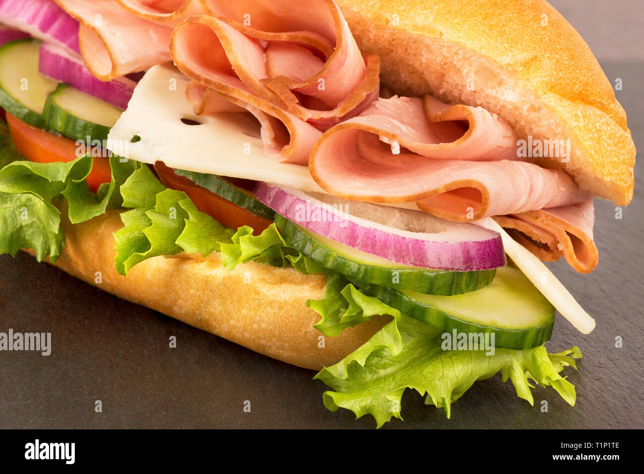 Close up on submarine ham sandwich, disposed on grey slate Stock Photo ...