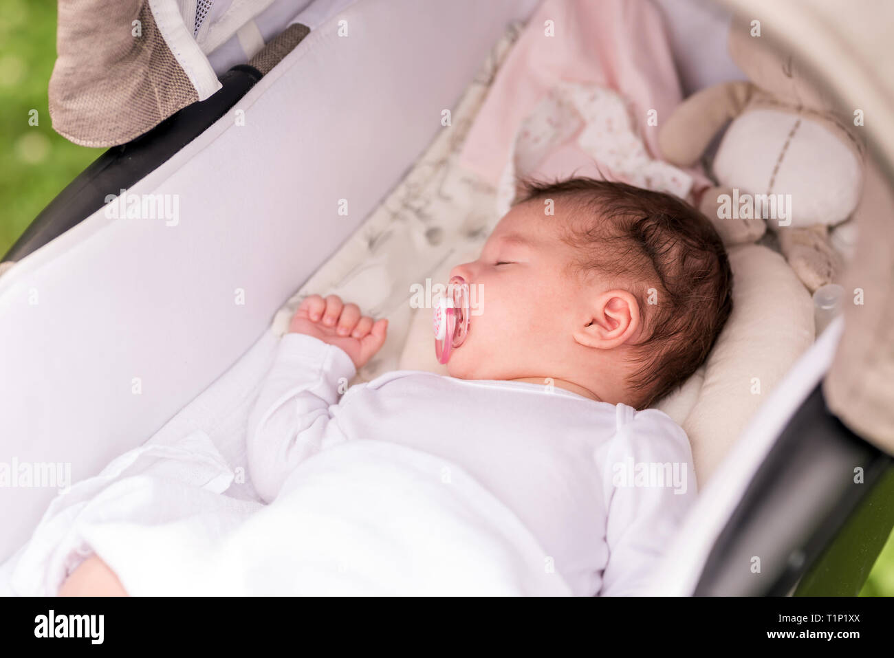 Baby girl sleeping in stroller hi-res stock photography and images - Alamy