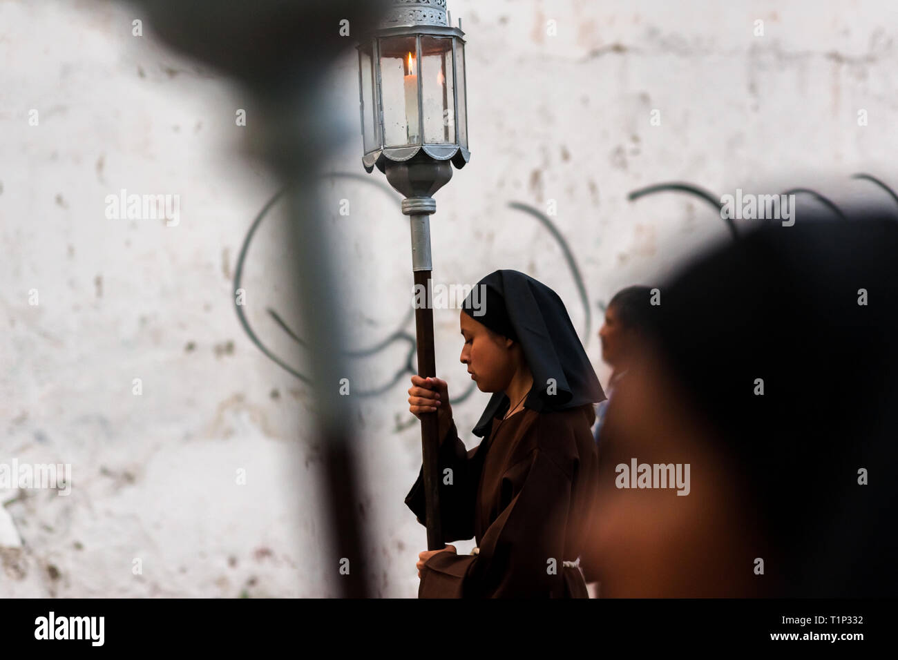 Catholic nuns, carrying procession lamps, walk in the Holy week ...