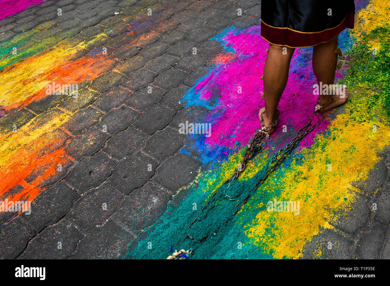 A Catholic devotee, with cactus spines stuck to his legs, drags chains ...