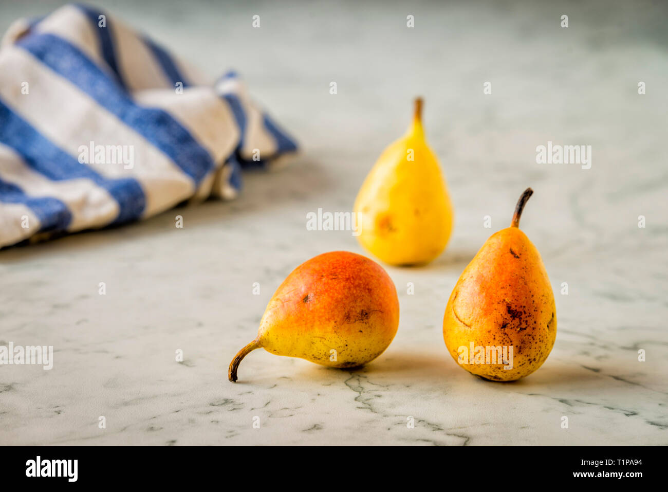 Three fresh pears on a marble surface Stock Photo - Alamy