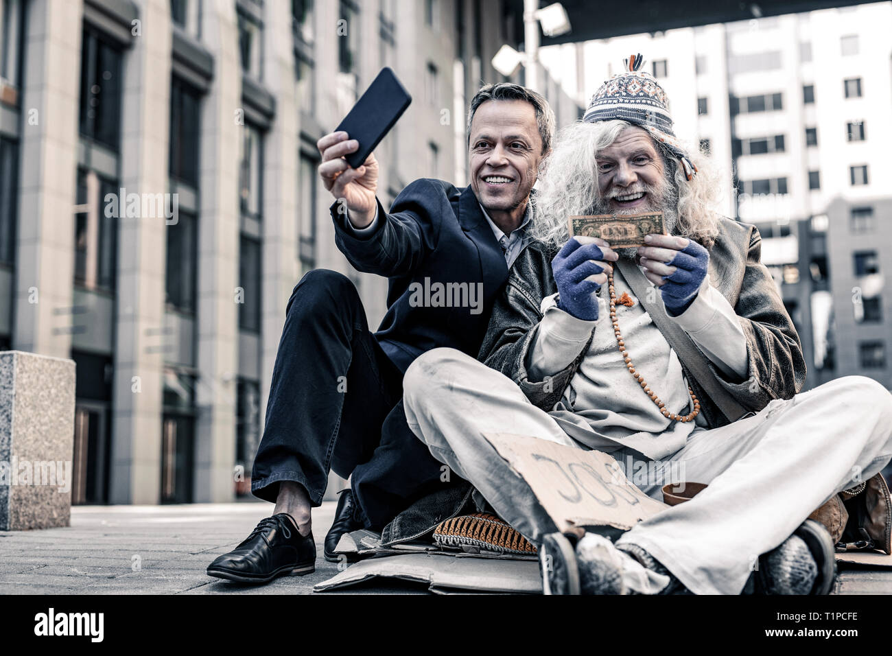 Vain rich man in costume making selfie of donation money Stock Photo ...