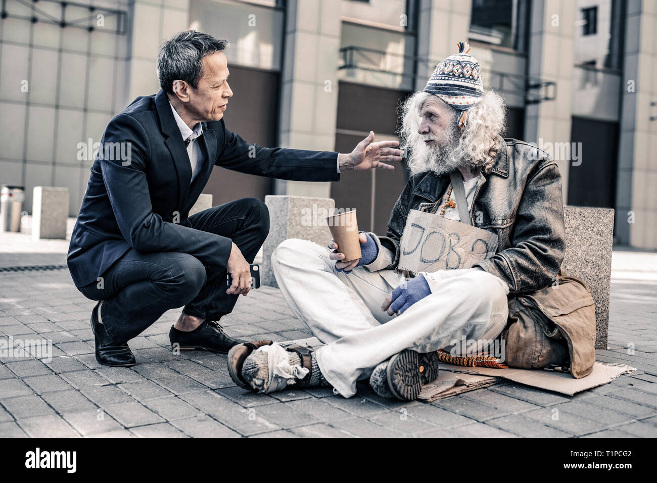 Helpful caring man in costume putting hand on shoulder of dirty ...