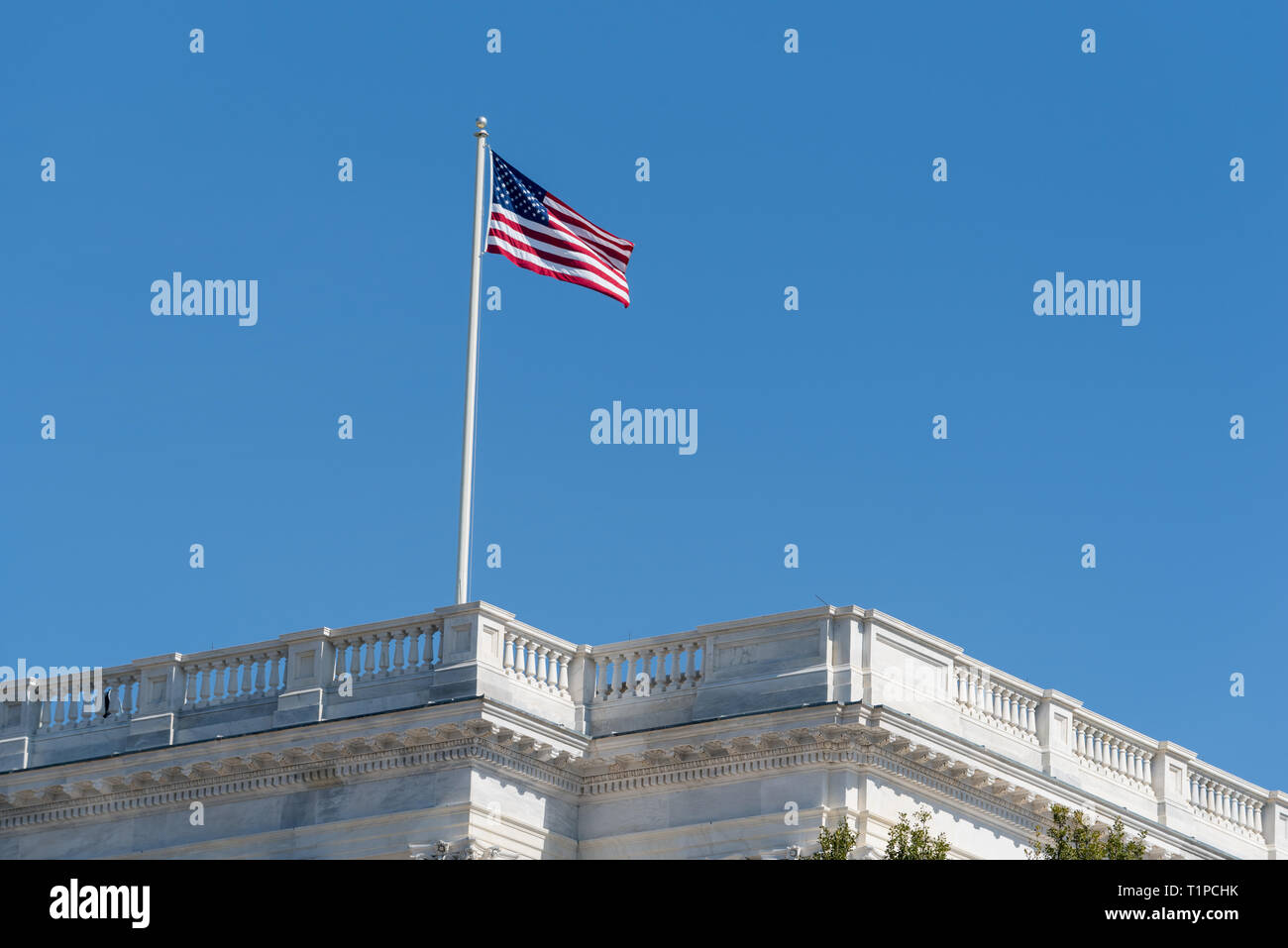 American flag flying from roof of Senate wing of US Capitol Building in ...