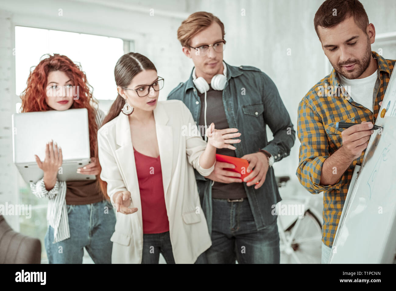 Smart young woman saying her comments about presentation Stock Photo ...