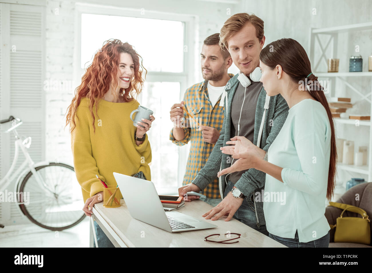 Good looking young people speaking about work Stock Photo - Alamy