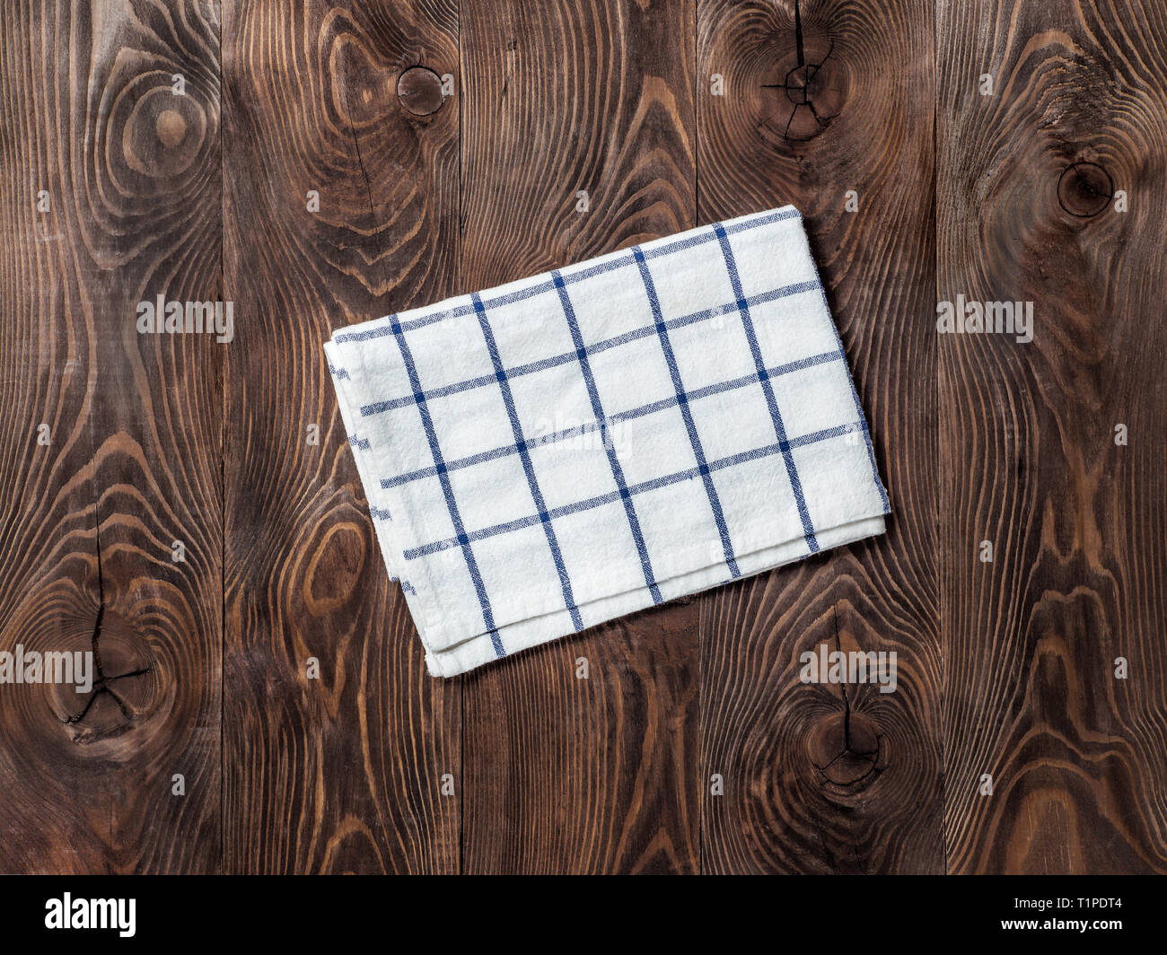 View from above on brown wooden table with linen kitchen towel or ...