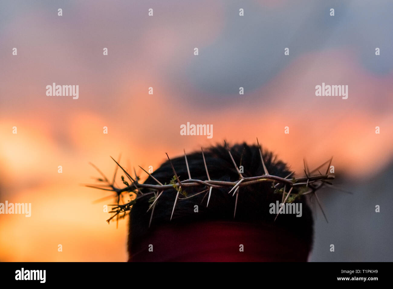 A hooded Catholic penitent is seen wearing a crown of thorns during the ...