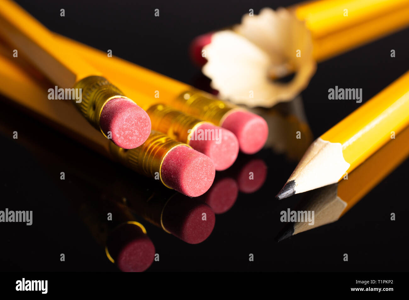 Group of six whole yellow pencil fan-shaped shaving isolated on black ...