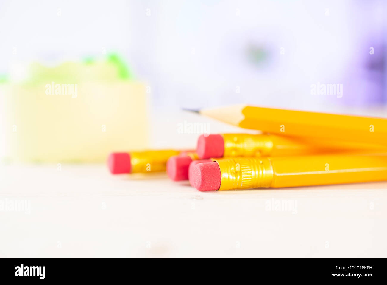 Group of five whole yellow pencil with a sticker roll with red flowers ...