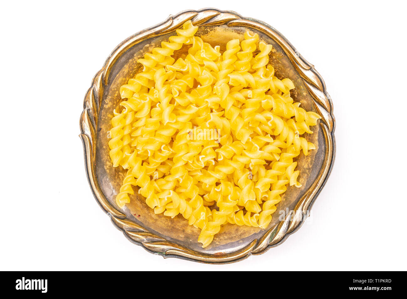 Lot of pieces of raw italitan yellow pasta torti in old iron bowl ...