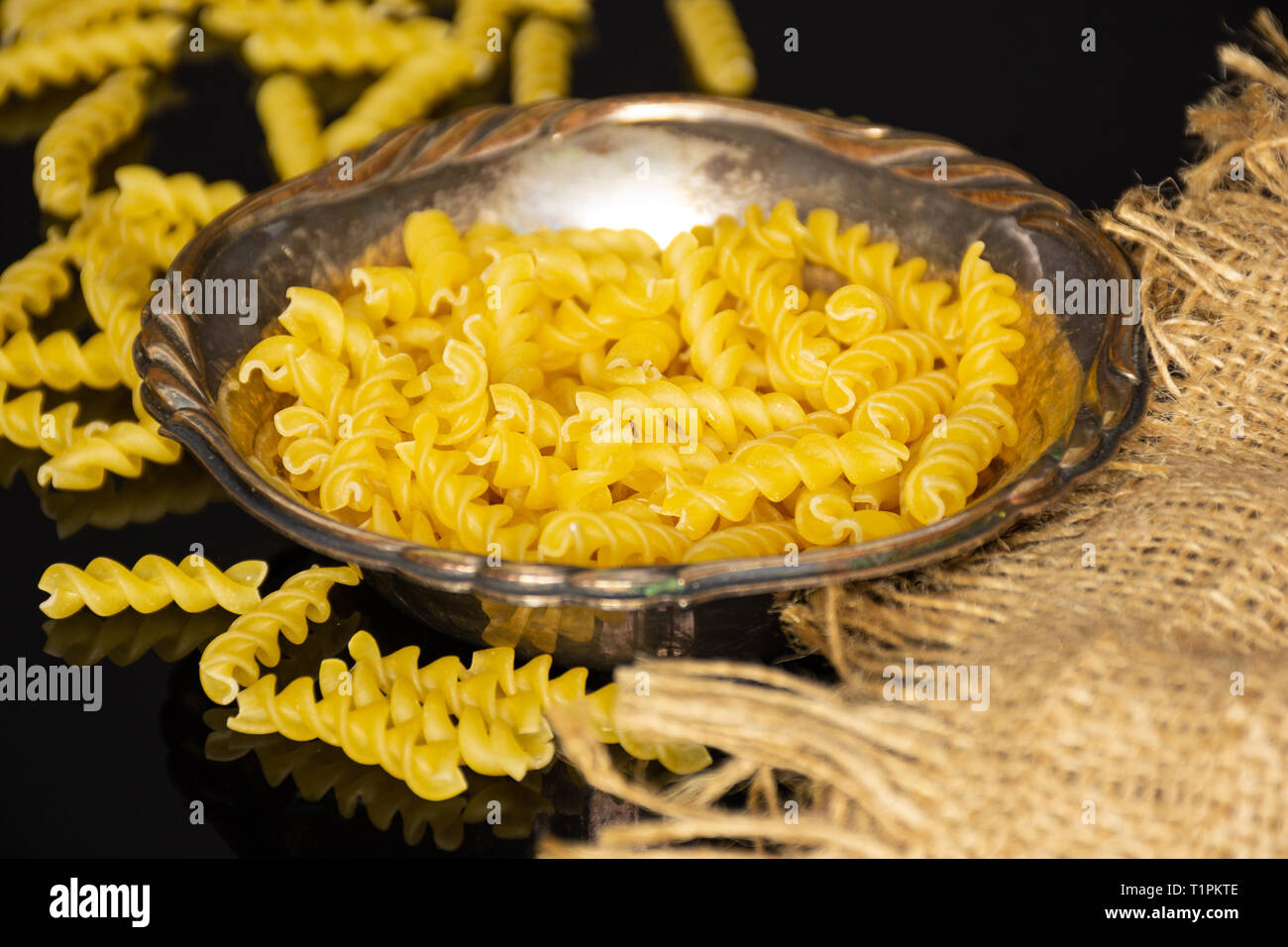 Lot of pieces of raw italitan yellow pasta torti on jute cloth in old ...