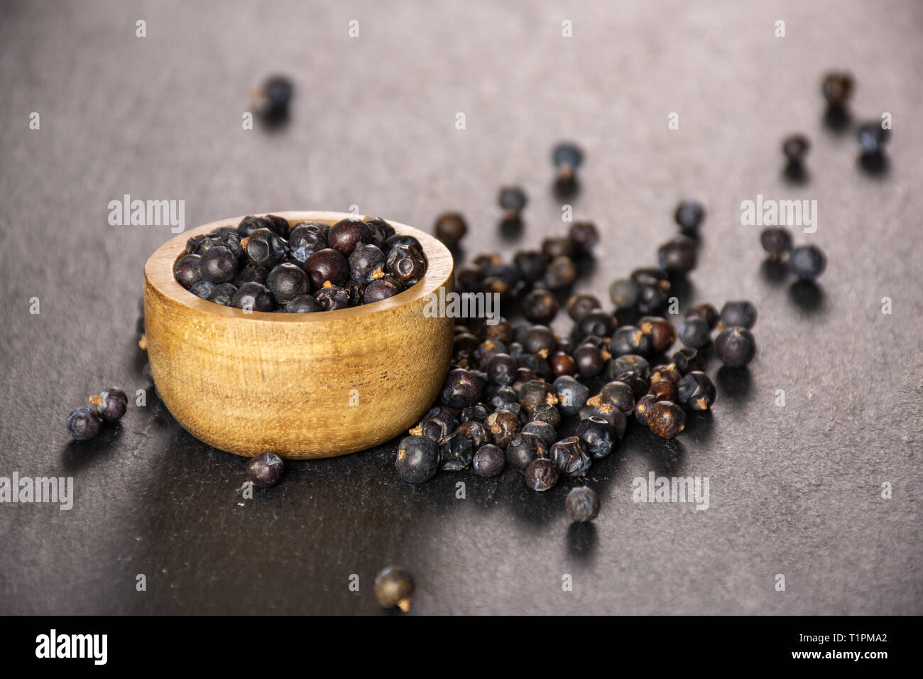 Lot of whole dry juniper berry seed on grey stone Stock Photo - Alamy