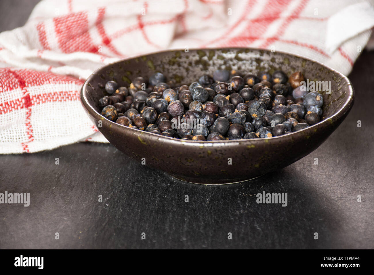 Lot of whole dry juniper berry seed on grey stone Stock Photo - Alamy