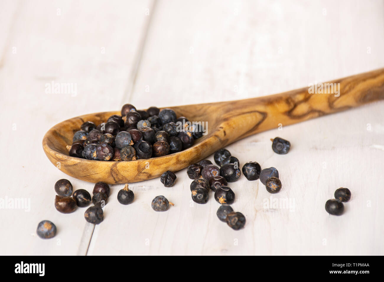 Lot of whole dry juniper berry seed on white wood Stock Photo - Alamy
