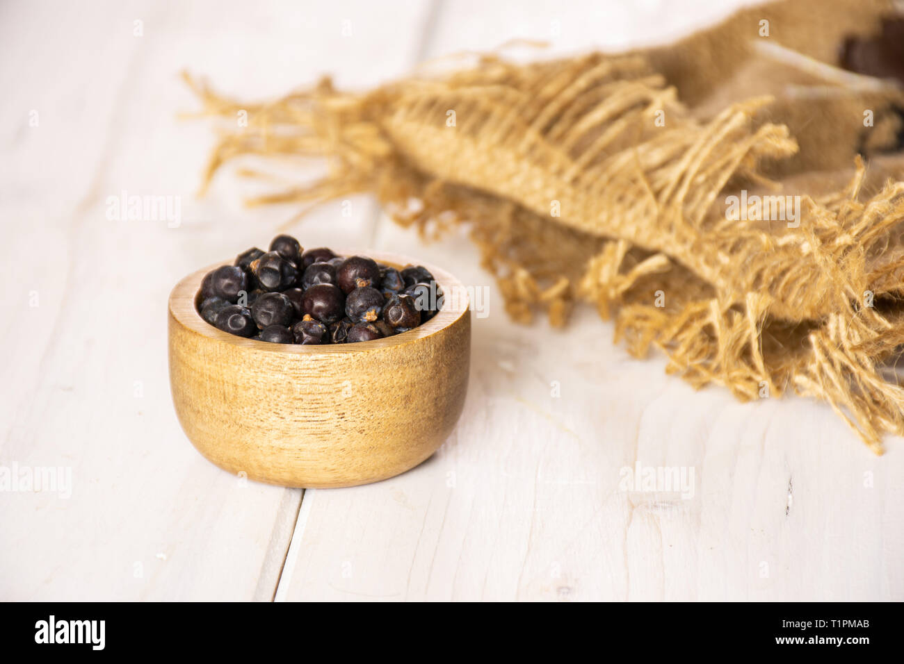 Lot of whole dry juniper berry seed on white wood Stock Photo - Alamy