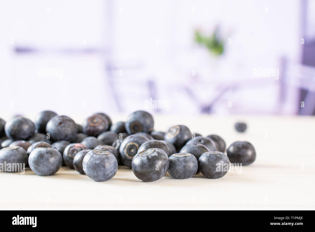 Lot of whole fresh sweet purple blueberry american with red flowers on ...