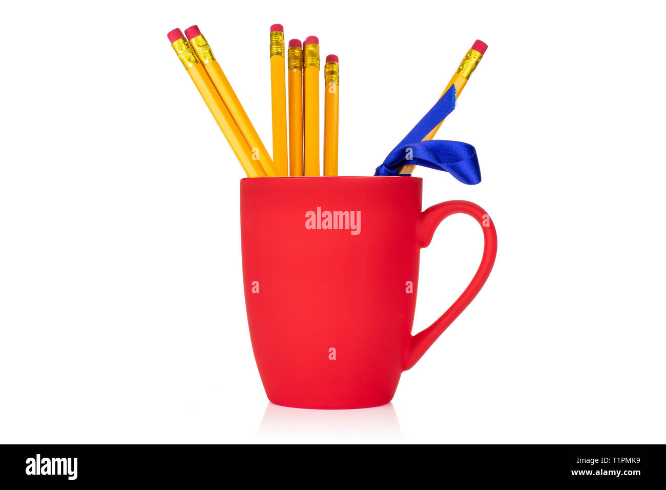 Group of seven whole yellow pencil tied by ribbon in a red cup isolated ...
