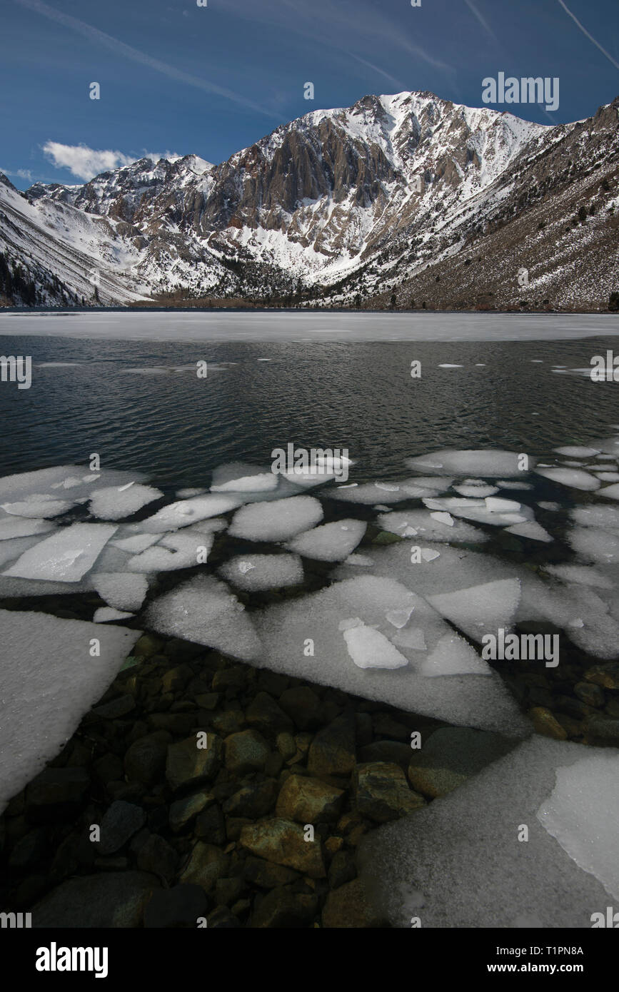 A biting cold wind blows down from the mountains, mocking the sunny ...