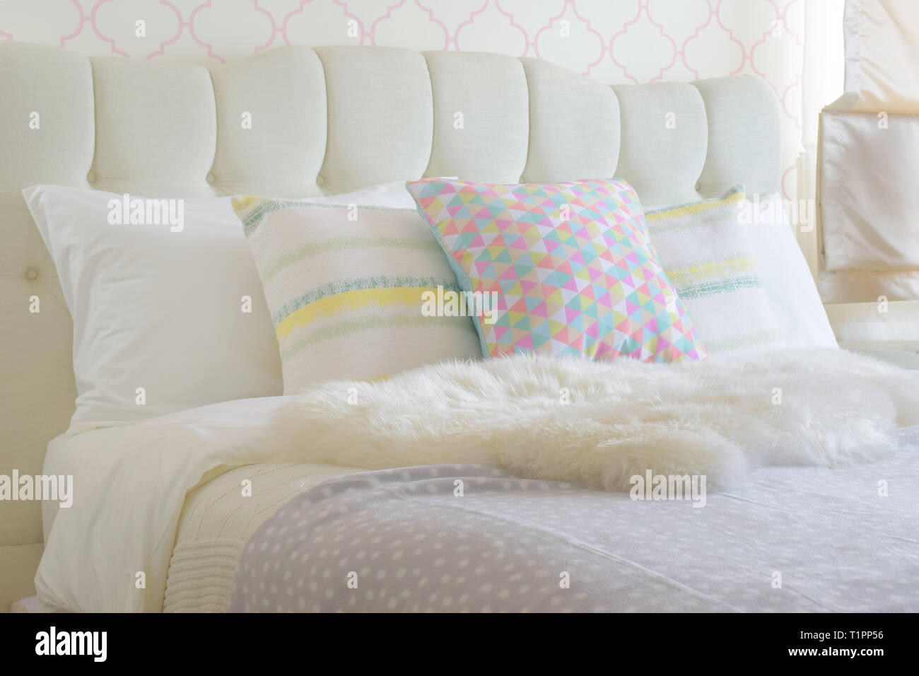 Sweet colorful pillows setting on bed with puffy scarf Stock Photo - Alamy