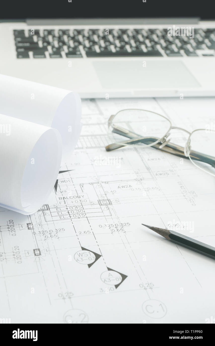 black pencil and computer laptop on architectural drawing paper for ...