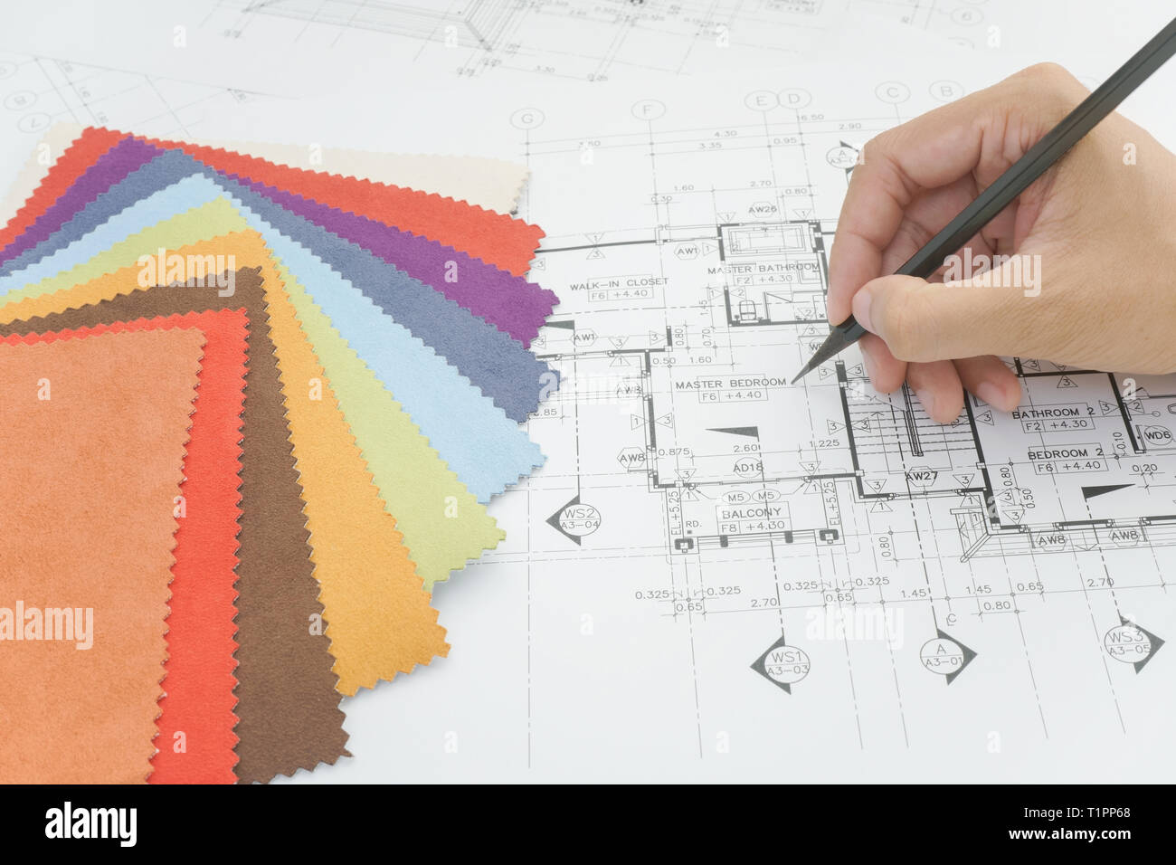 architects hands drawing of modern house with colors and material ...