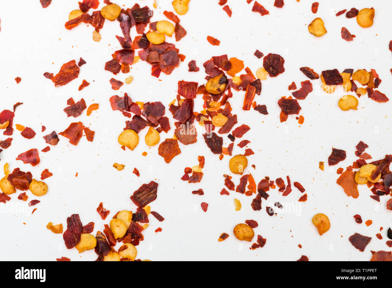 Crushed red peppers on white background Stock Photo - Alamy