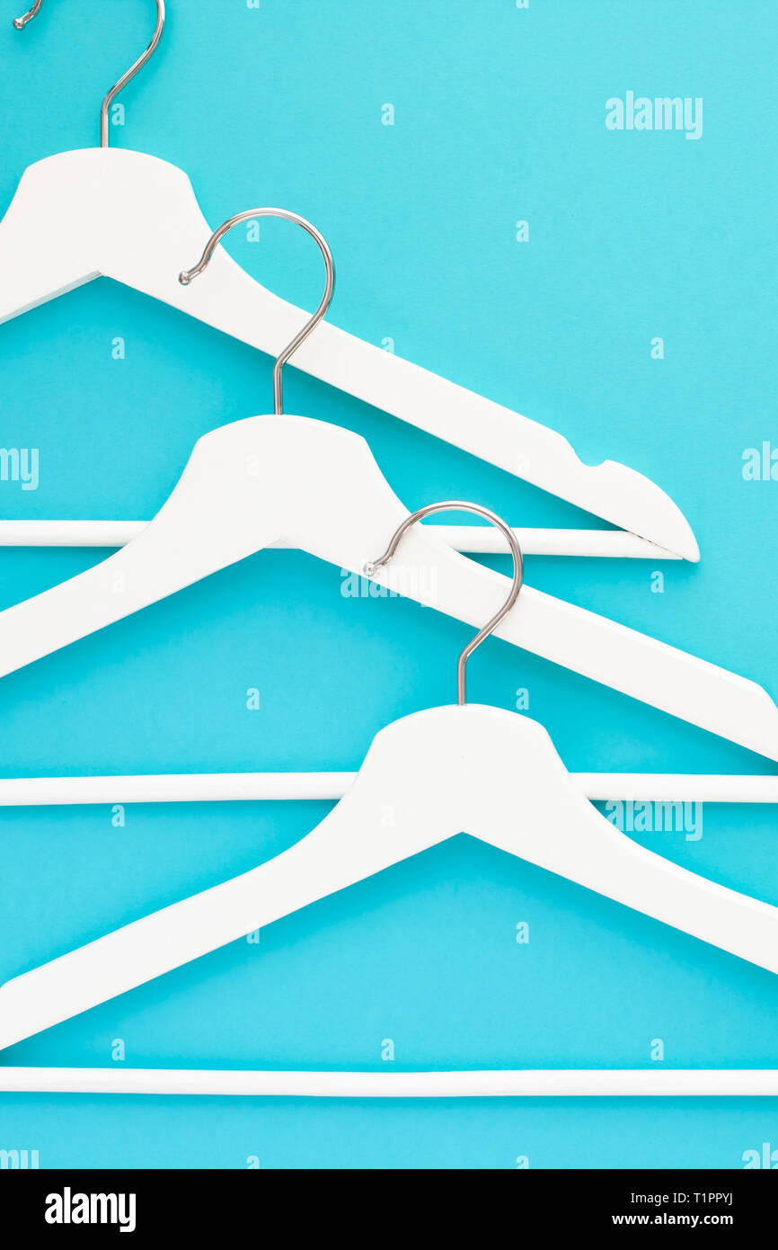 Creative top view flat lay white wooden hangers isolated bold blue ...