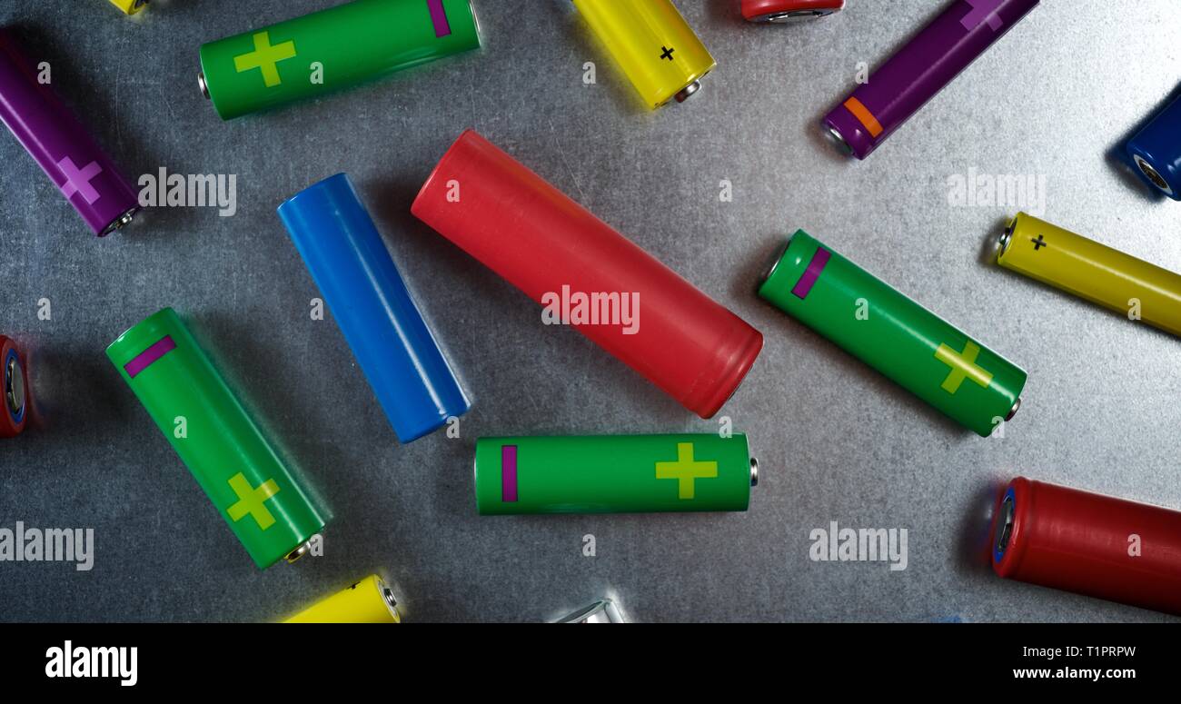 Many batteries on a metal table Stock Photo - Alamy