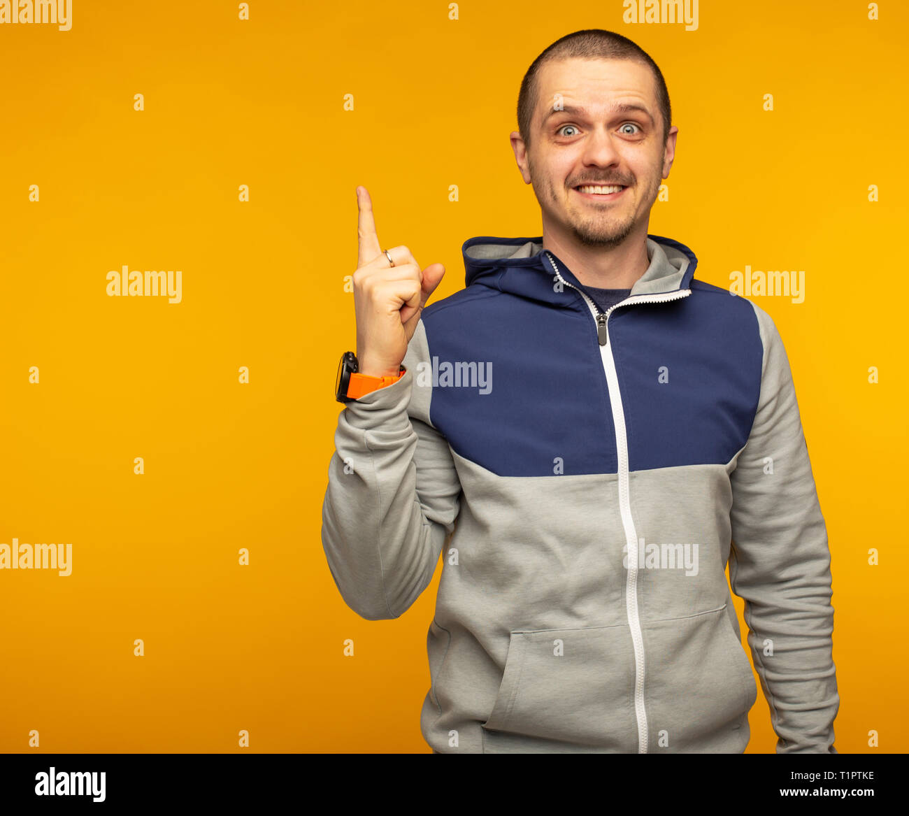 Smiling man pointing by hand and looking in camera Stock Photo - Alamy