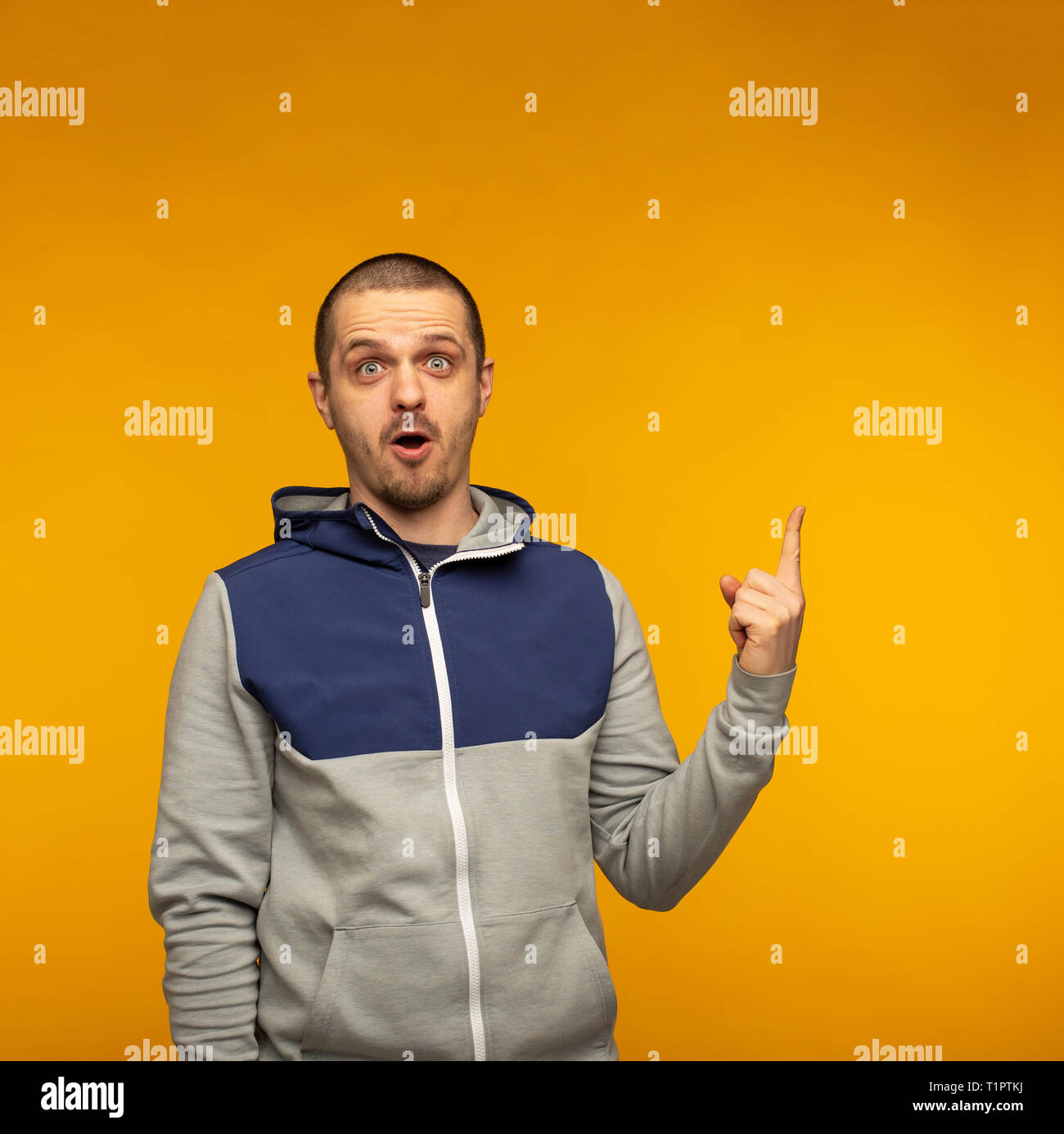 Surprised man showing something and looking in camera Stock Photo - Alamy