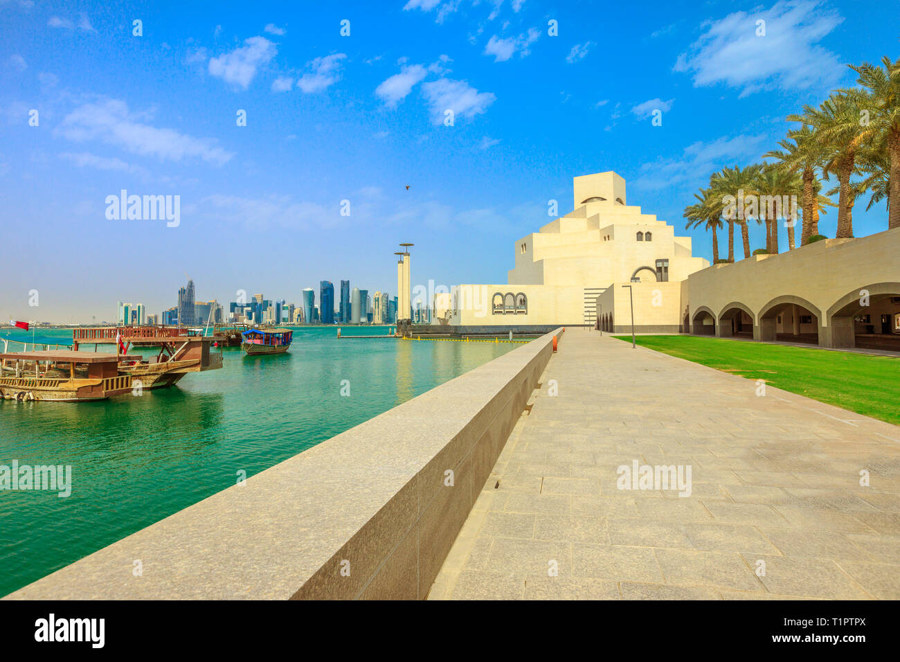 Doha seafront with palm trees and West Bay skyline along Corniche in ...