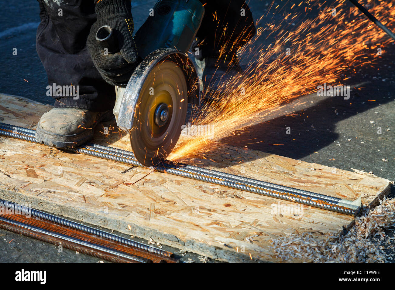 An employee in white overalls and a protective mask processes with ...