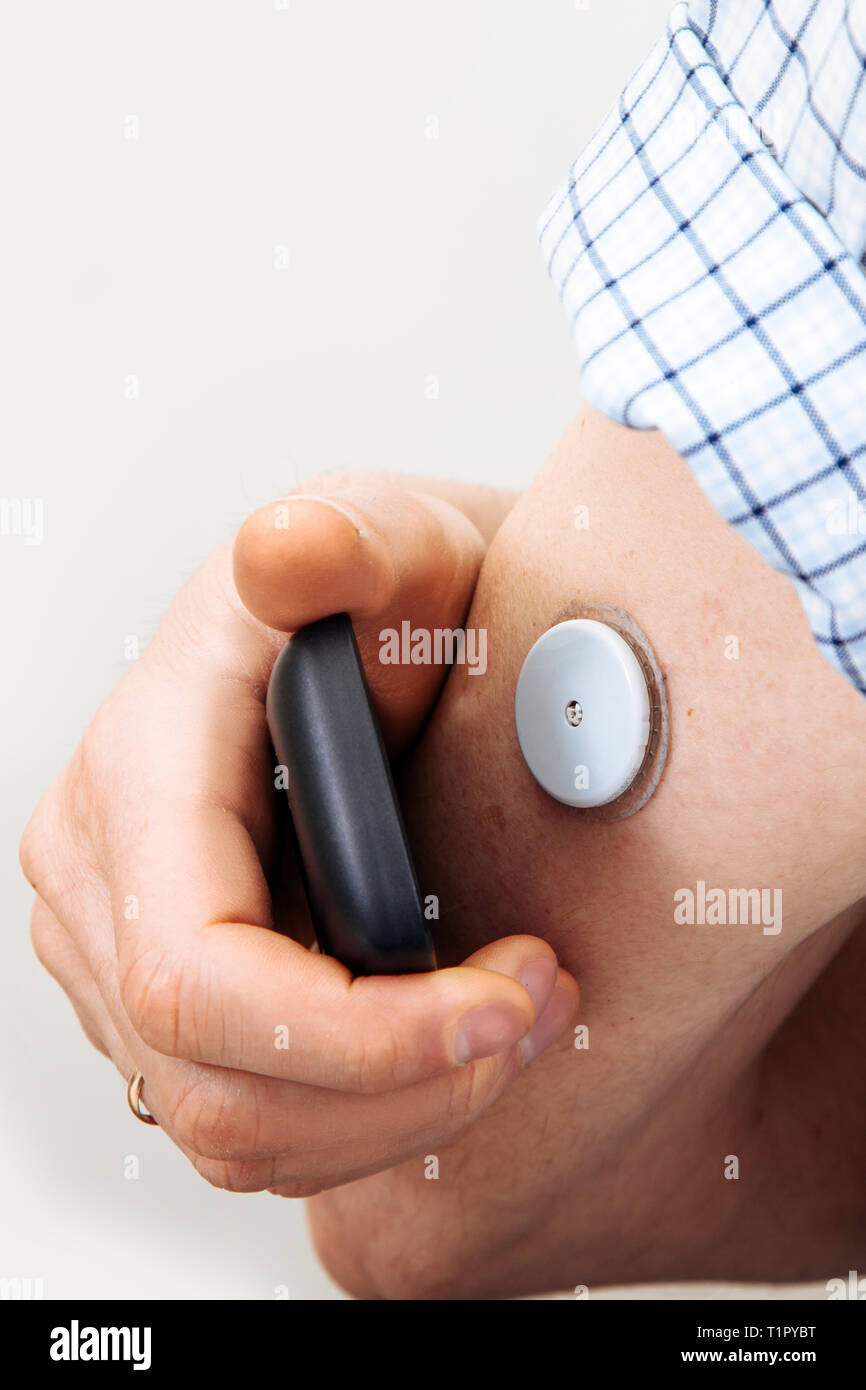 Man testing glucose level with a digital glucometer, sensor checkup ...