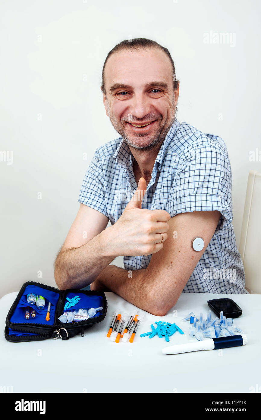 Man testing glucose level with a digital glucometer, sensor checkup ...