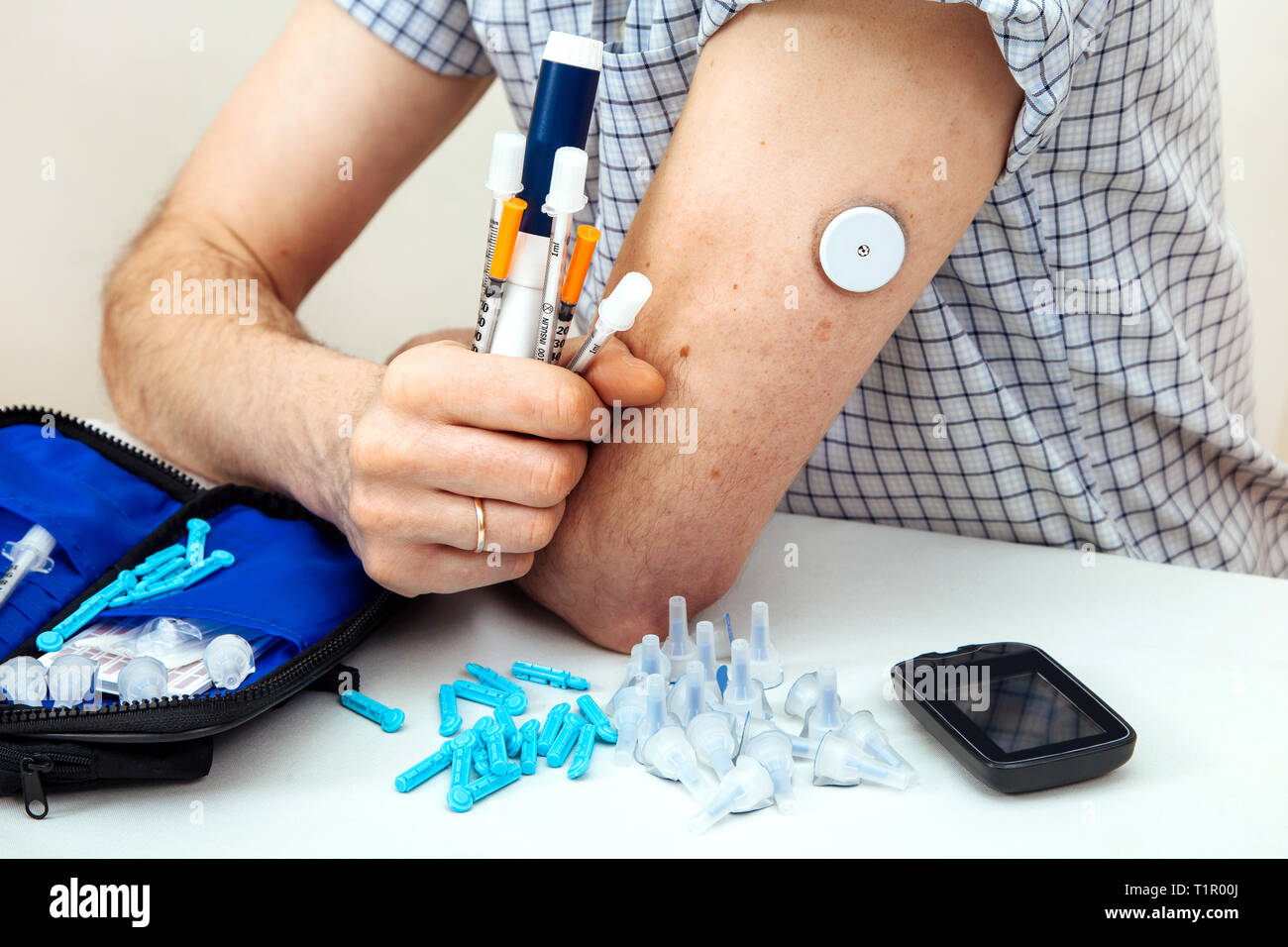 Man testing glucose level with a digital glucometer, sensor checkup ...