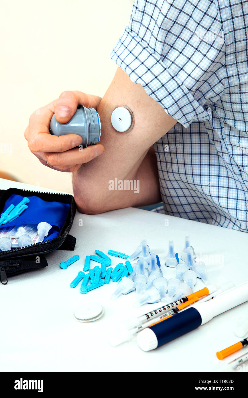 Man testing glucose level with a digital glucometer, sensor checkup ...