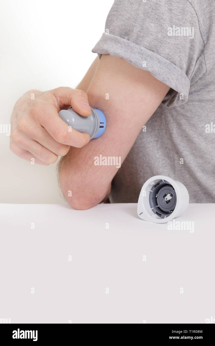 Man testing glucose level with a digital glucometer, sensor checkup ...