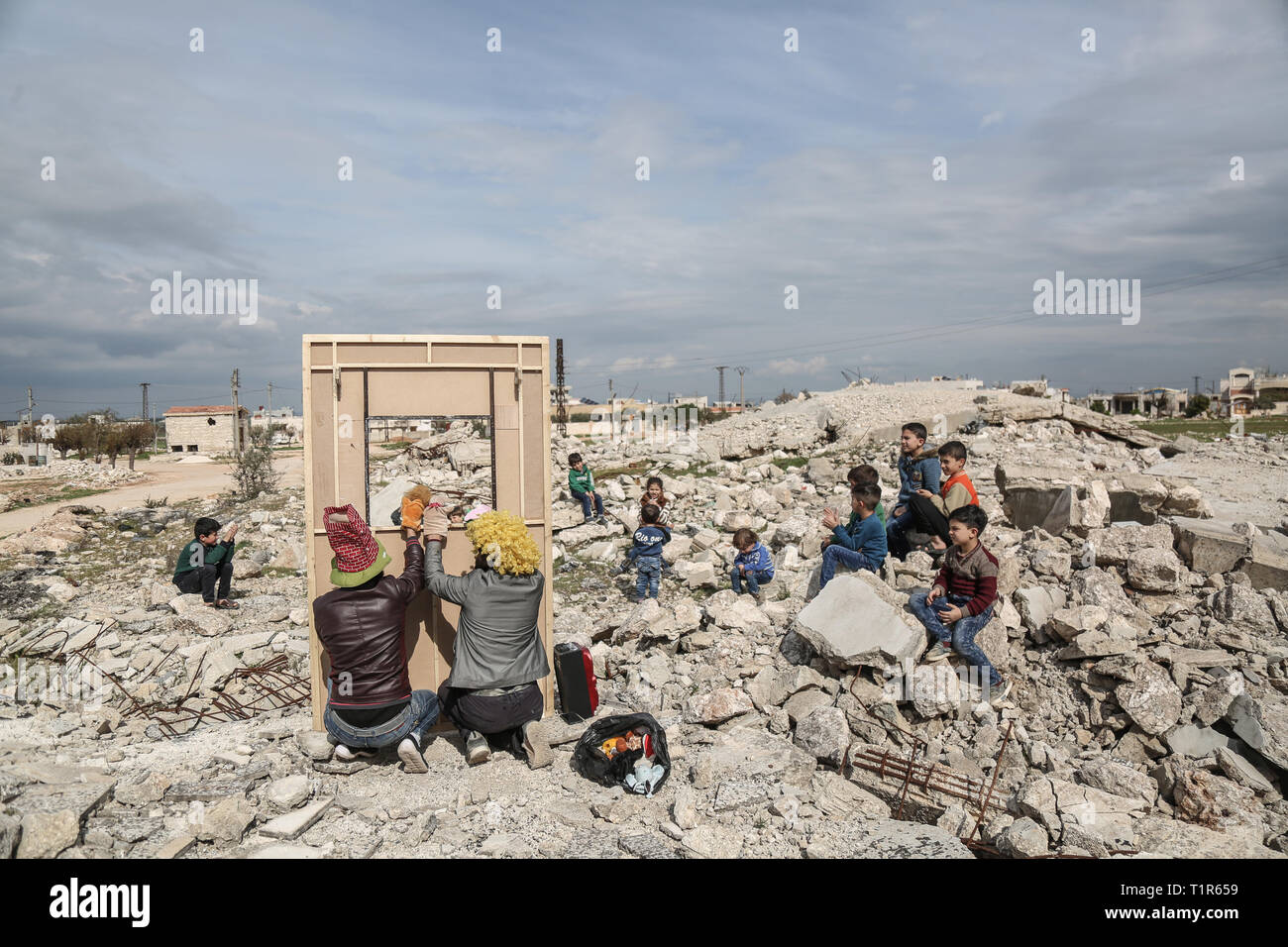 Saraqib, Syria. 27th Mar, 2019. Puppeteer Walid Rashed performs a ...