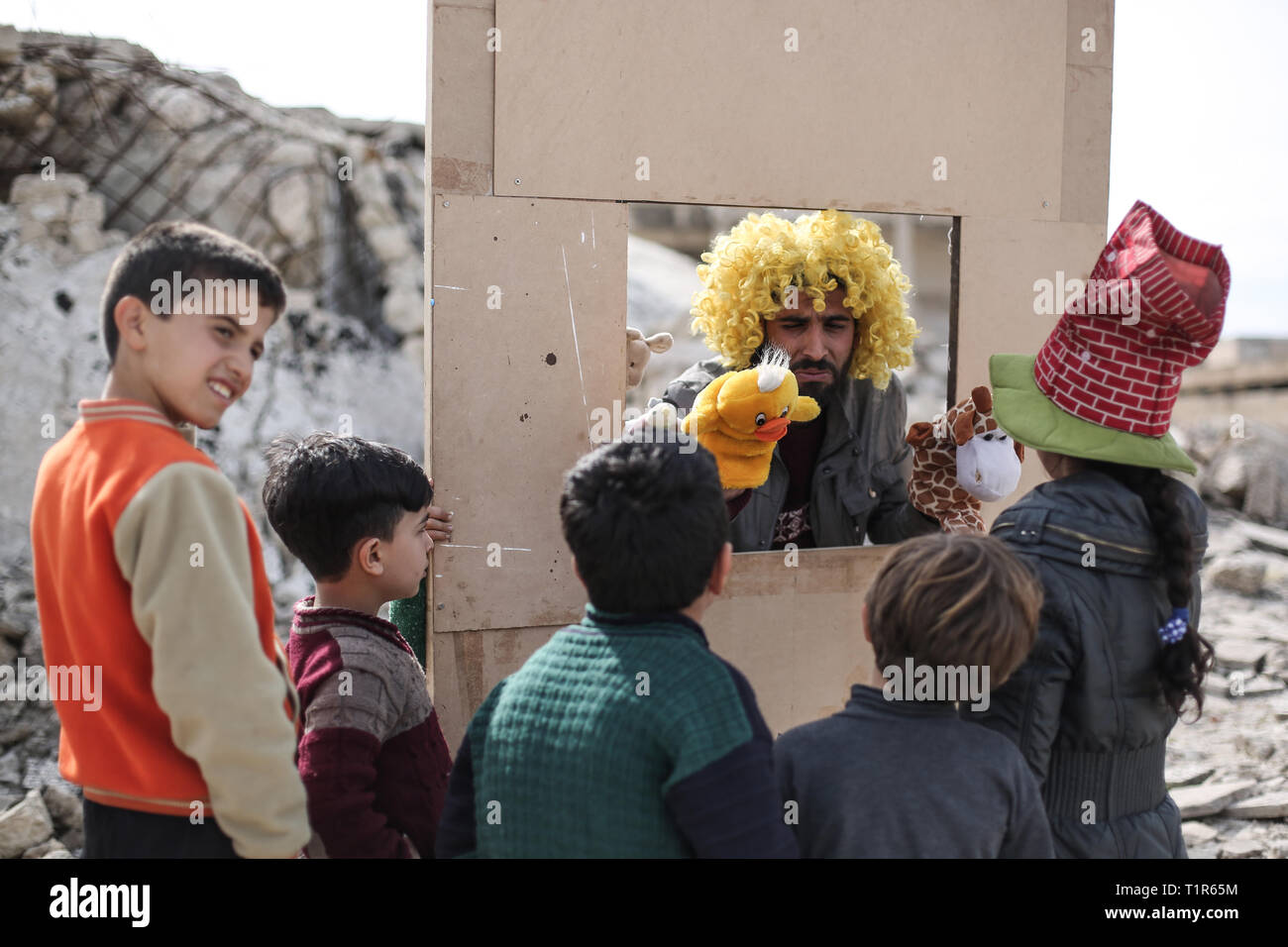 Saraqib, Syria. 27th Mar, 2019. Puppeteer Walid Rashed performs a ...
