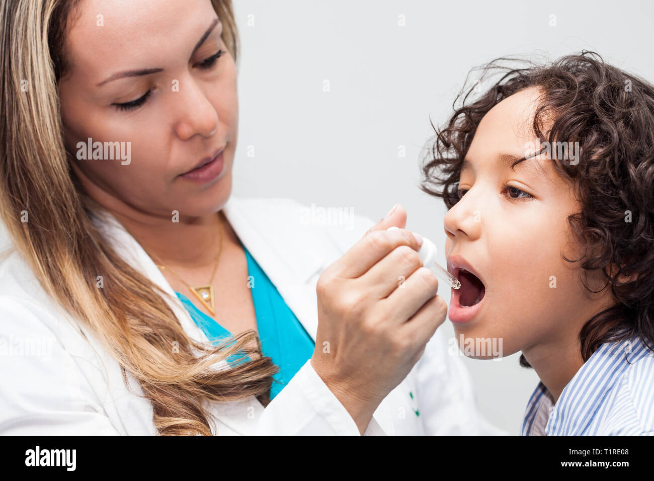 Doctor giving a child homeopathic medicine Stock Photo - Alamy