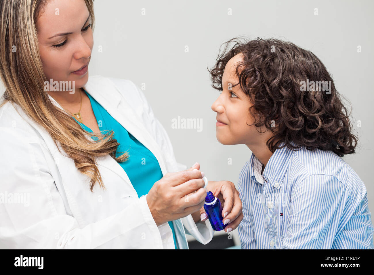 Doctor giving a child homeopathic medicine Stock Photo - Alamy