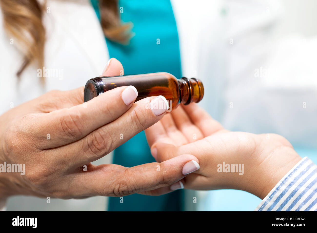 Doctor giving a child homeopathic medicine Stock Photo - Alamy