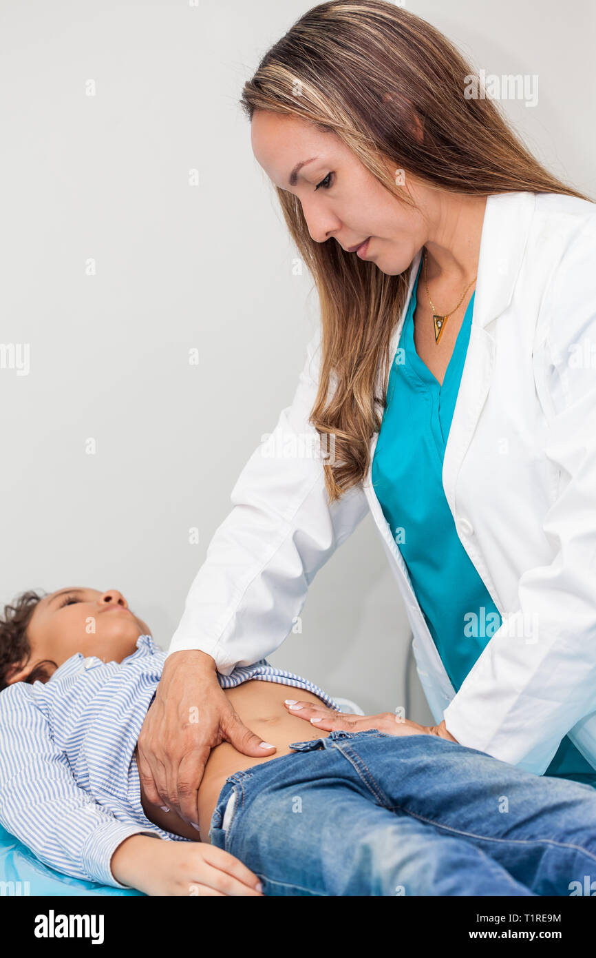 Doctor examining and performing the technique of abdominal percussion ...