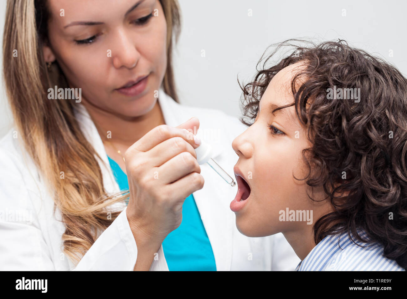 Doctor giving a child homeopathic medicine Stock Photo - Alamy