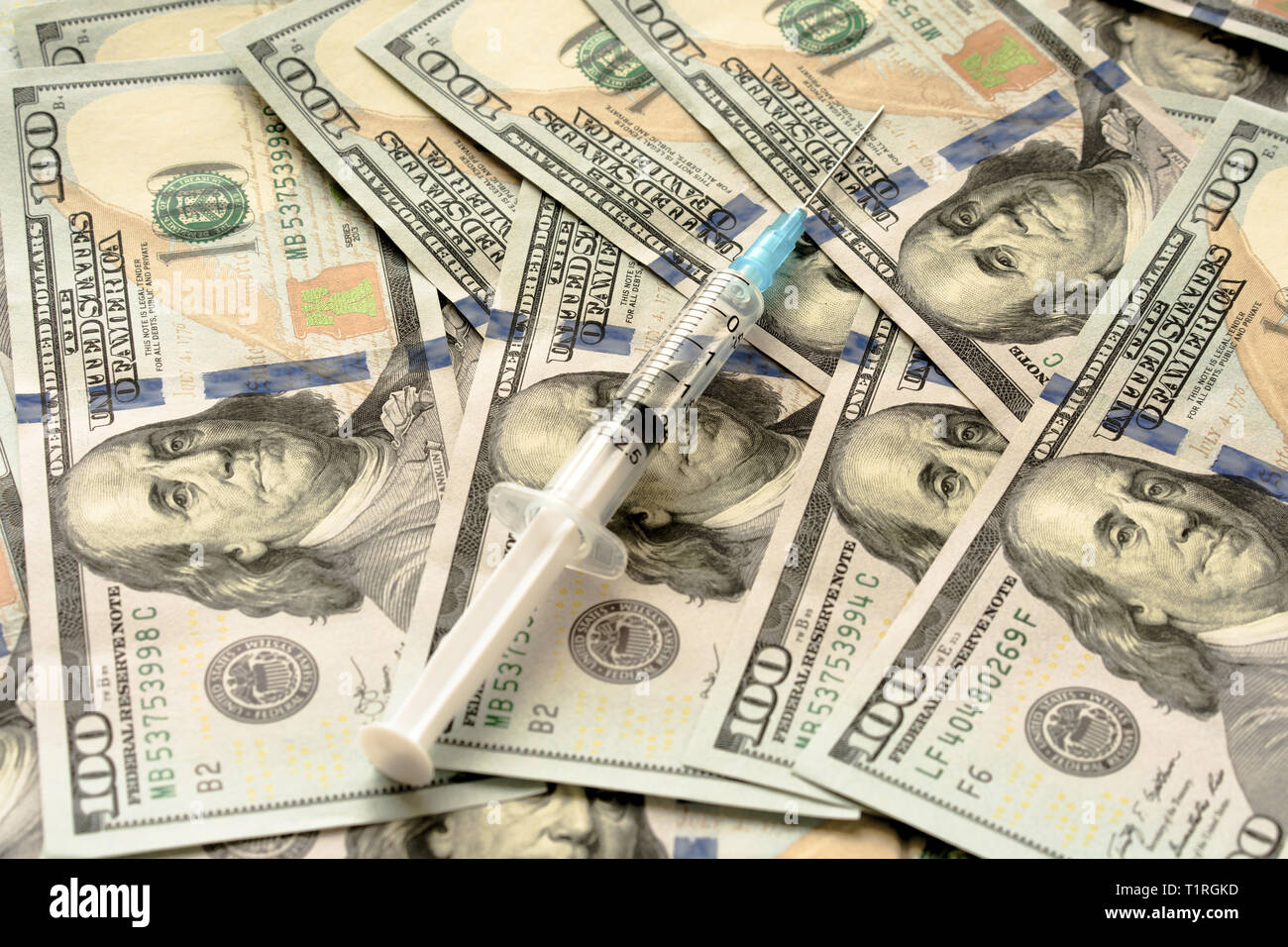 close up of syringe with injection on dollar banknotes Stock Photo - Alamy