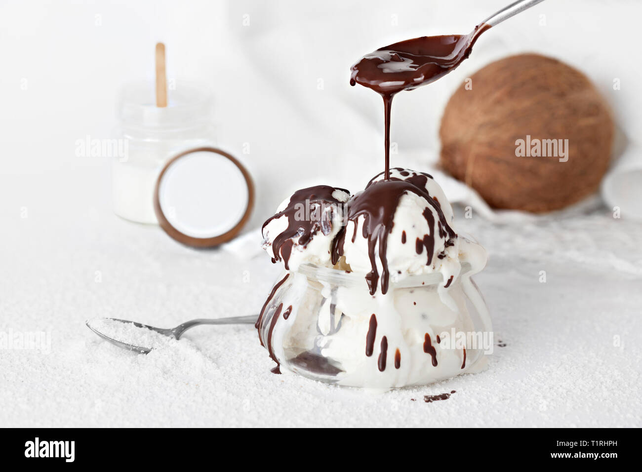 Dripping chocolate on coconut ice cream Stock Photo - Alamy